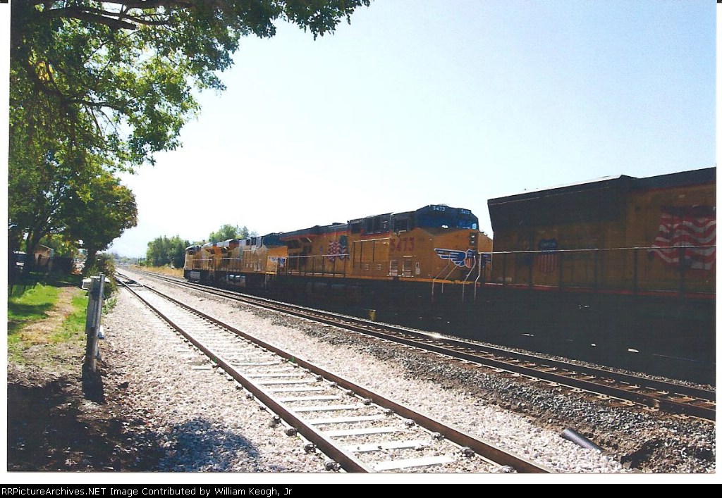 UP 5473 is the third unit on an west bound intermodal train